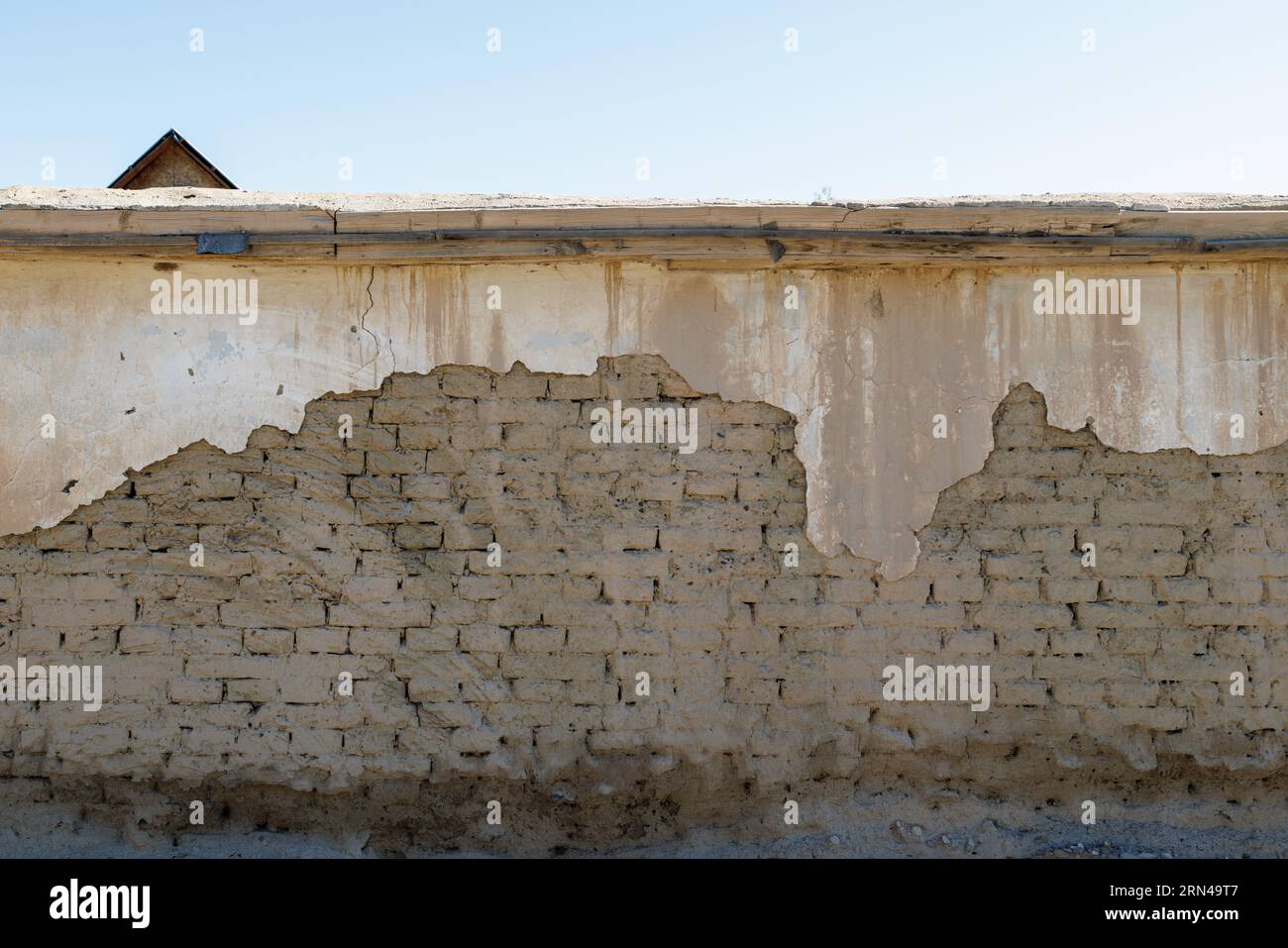 old adobe building wall with peeled off plaster Stock Photo - Alamy