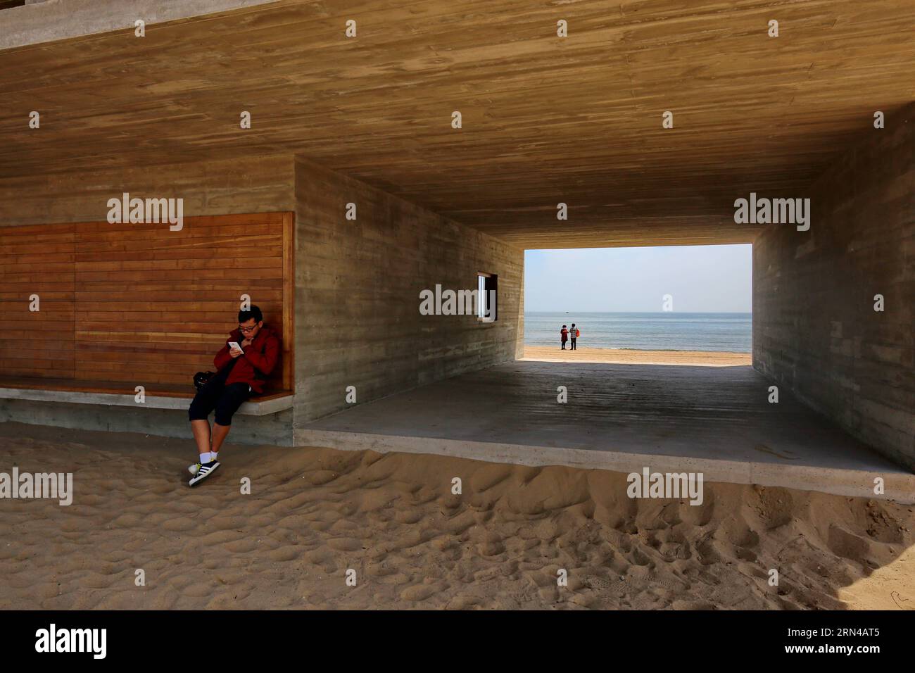 QINHUANGDAO, May 2015 -- A reader is seen at the seaside public library ...