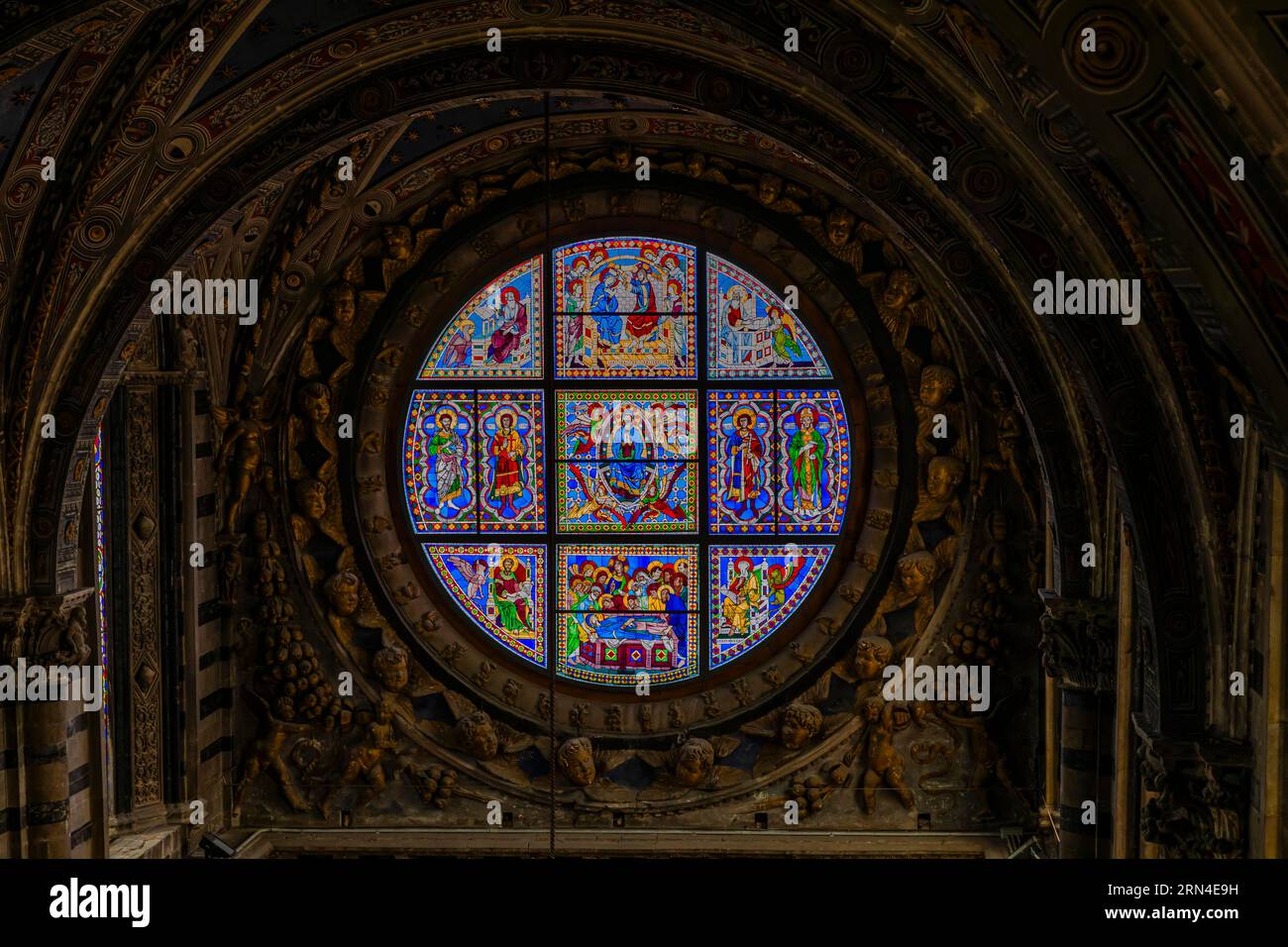 Coloured round window in the cathedral with vault and filigree ...