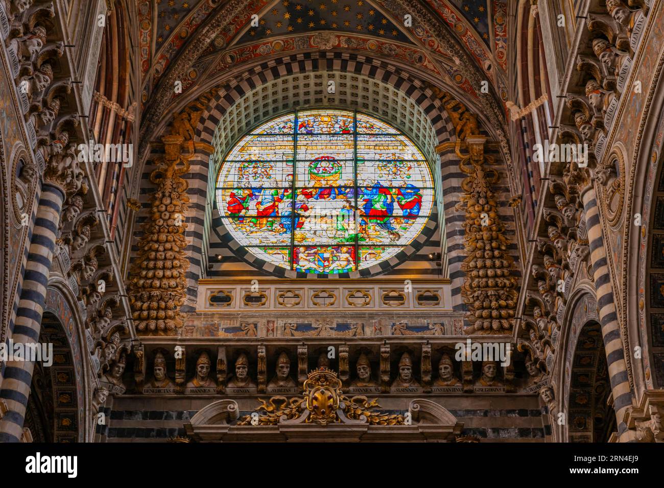 Coloured round window in the cathedral with filigree decoration ...