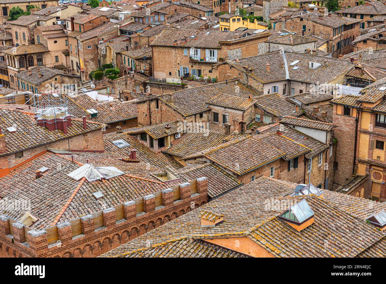 Above the rooftops in the historic centre of Siena, with its reddish ...