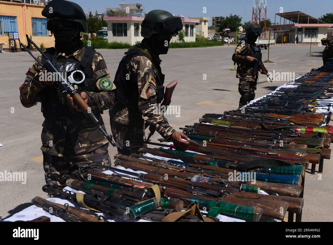 Afghan security forces display weapons captured from Taliban militants ...