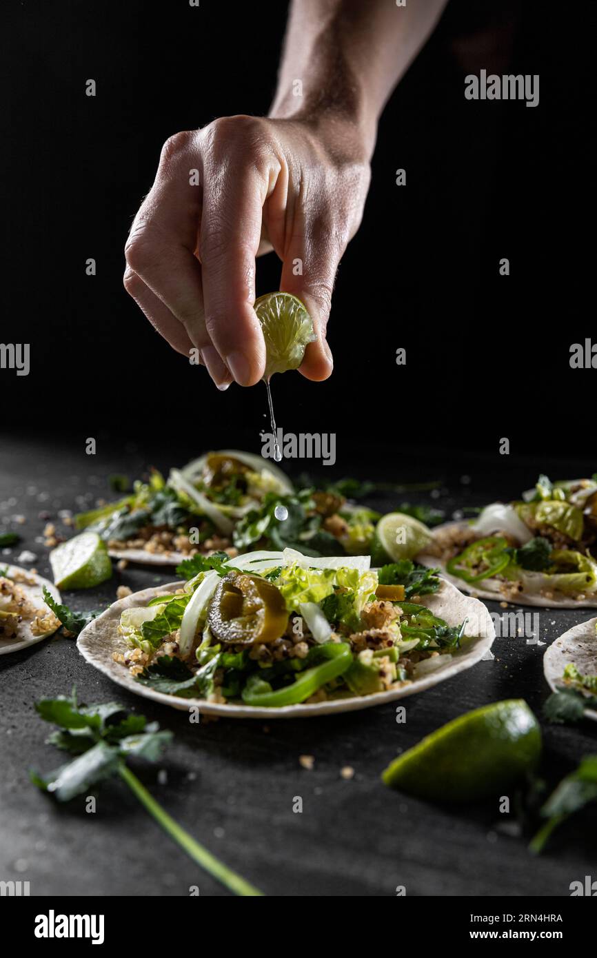 Close up hand squeezing lime taco Stock Photo - Alamy