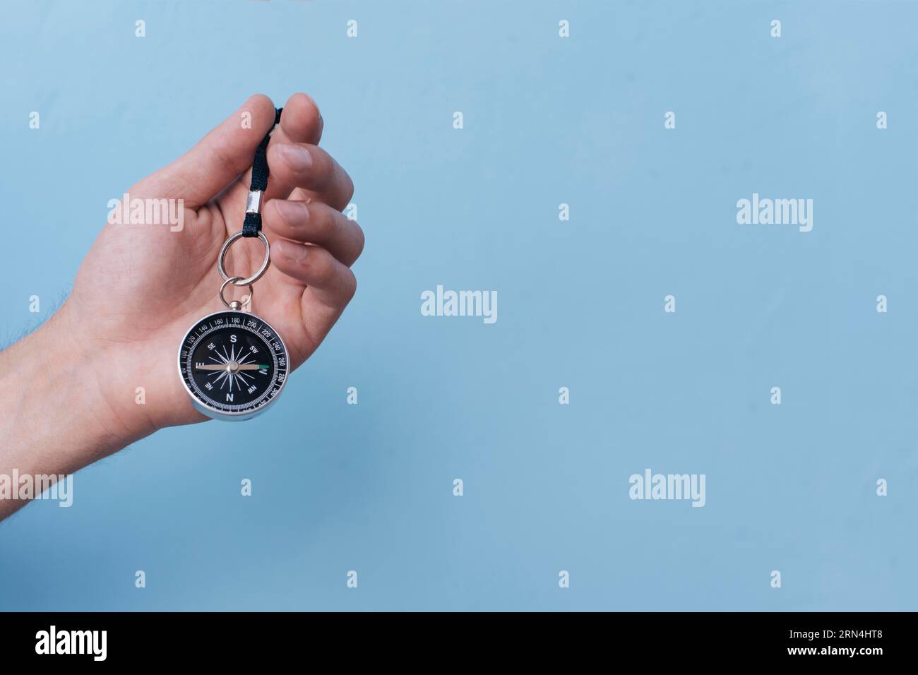 Close up human hand holding navigational compass blue backdrop Stock ...