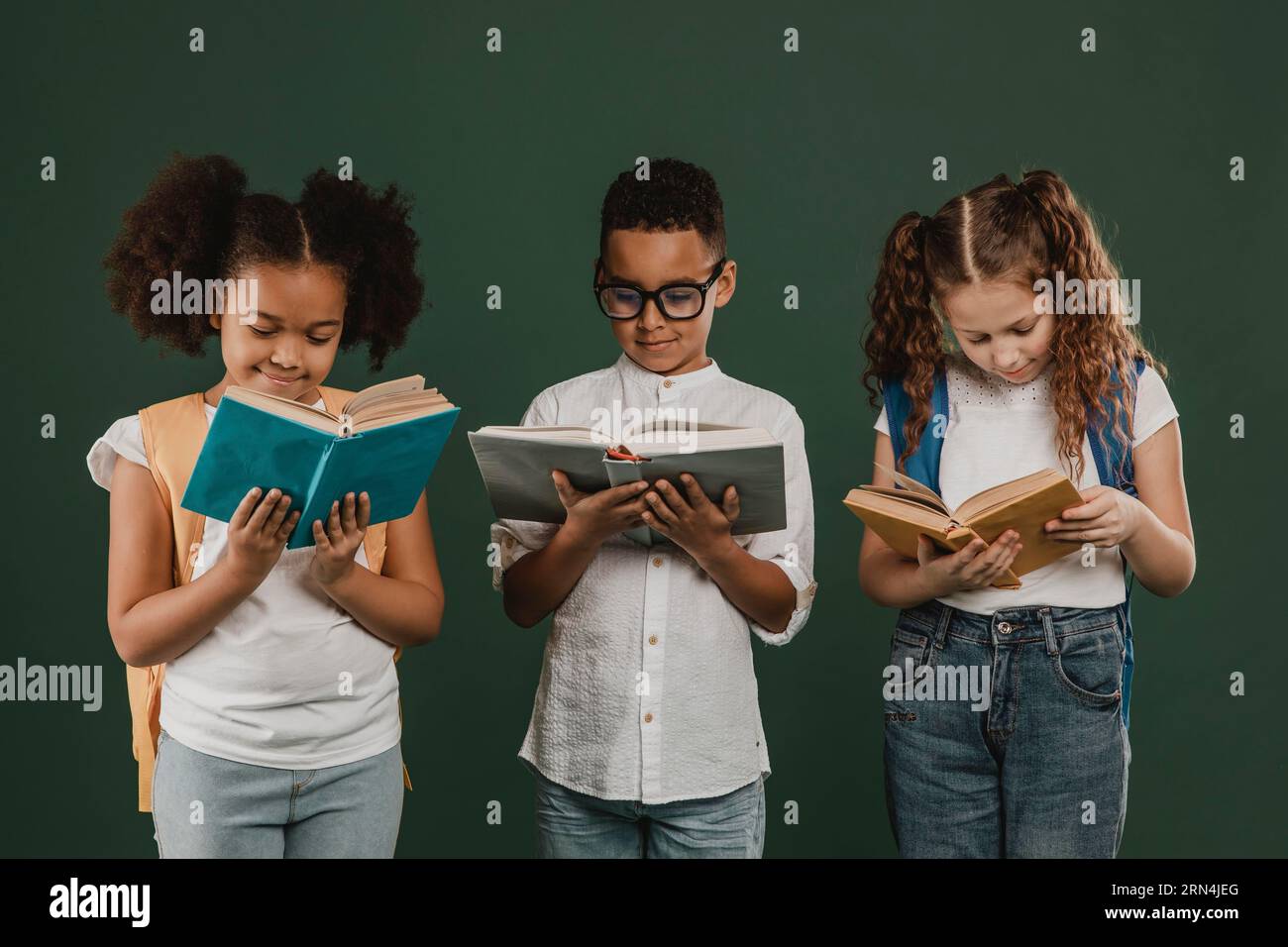 Front view school kids reading Stock Photo - Alamy