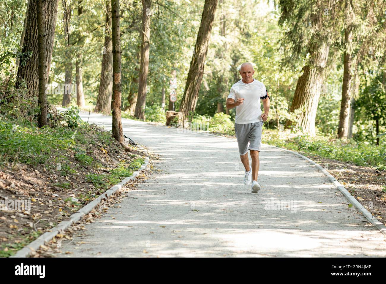 Full shot elder man running Stock Photo - Alamy