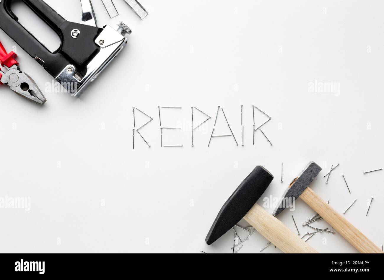 Hammers repair word written with nails Stock Photo - Alamy