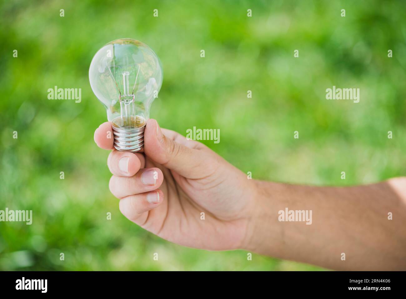 Human hand holding light bulb hi-res stock photography and images - Alamy
