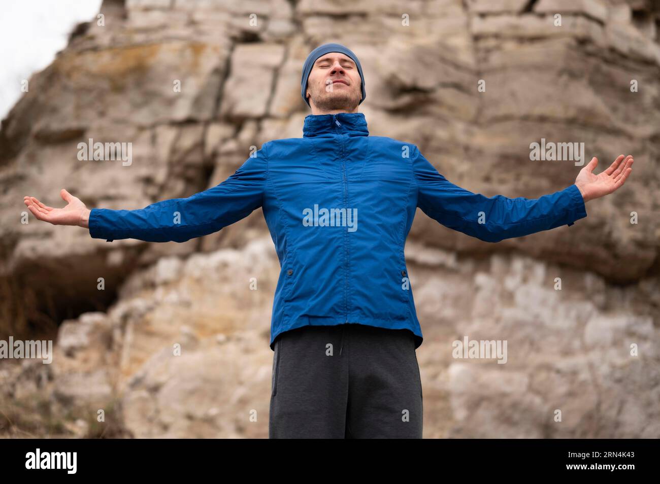 Man standing nature with arms open Stock Photo - Alamy