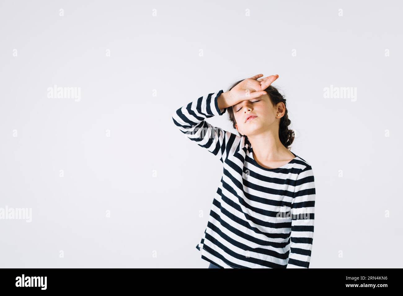 Sick girl touching forehead Stock Photo - Alamy