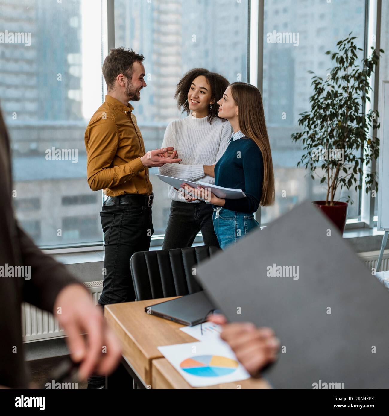 Smiley colleagues office during meeting Stock Photo - Alamy