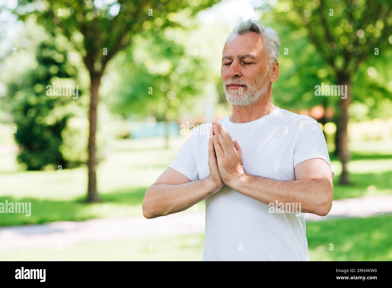 Side view man with hands meditating position Stock Photo - Alamy