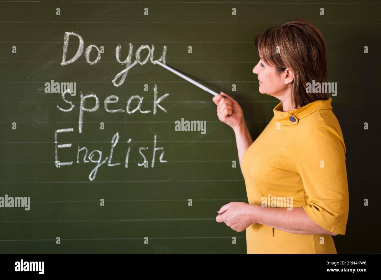 Side view teacher explaining chalkboard Stock Photo - Alamy