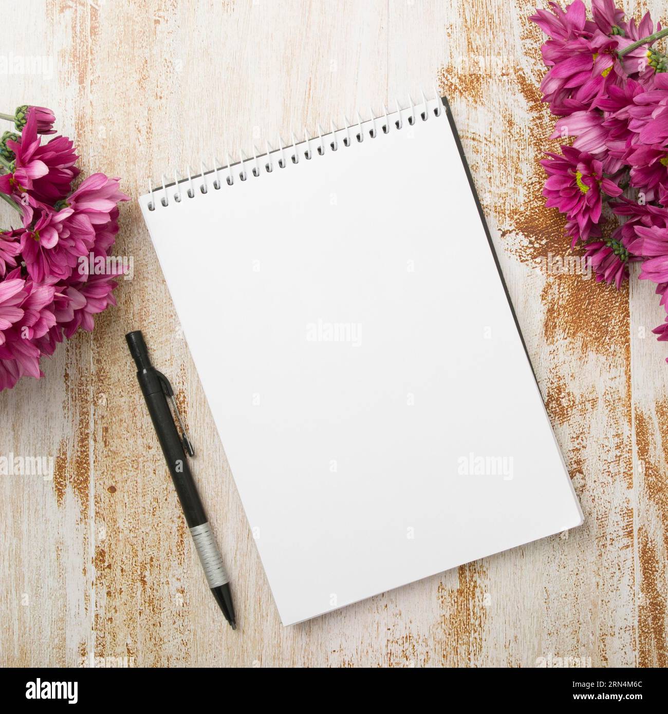 Spiral notepad with pen pink flowers wooden textured background Stock ...