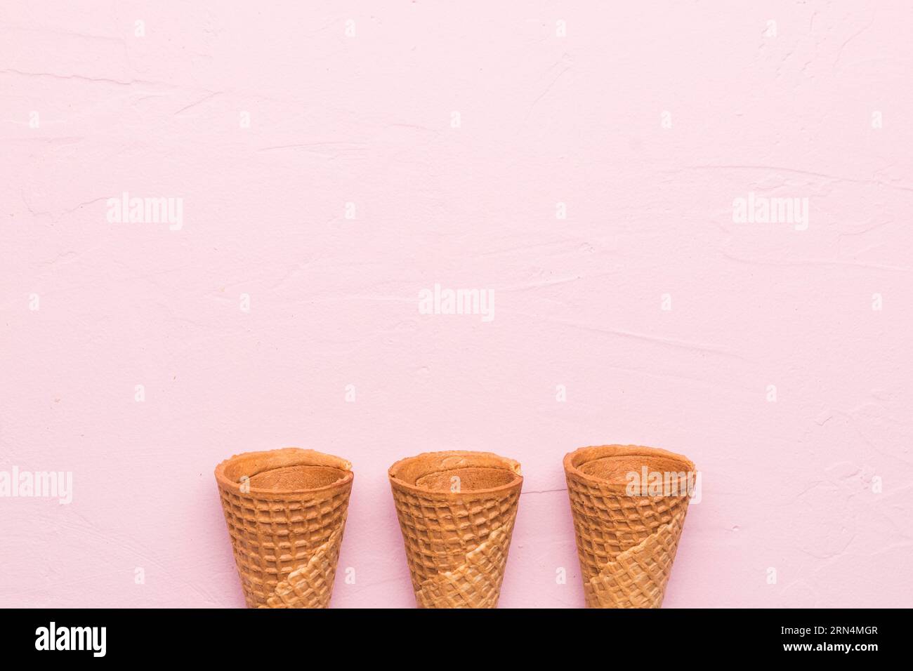 Waffle cones pink background Stock Photo - Alamy