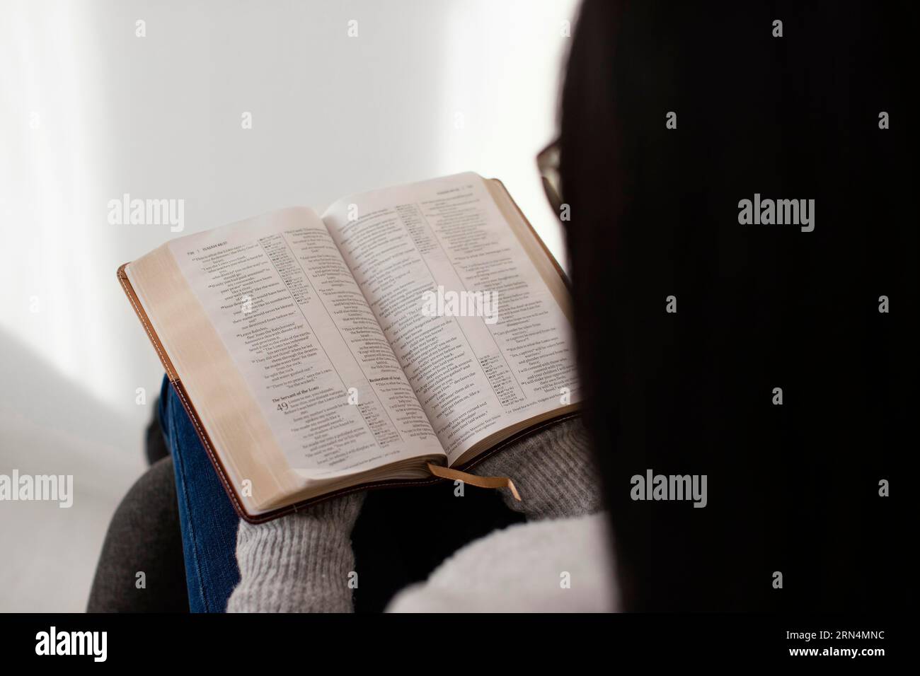 Woman reading bible indoors Stock Photo - Alamy