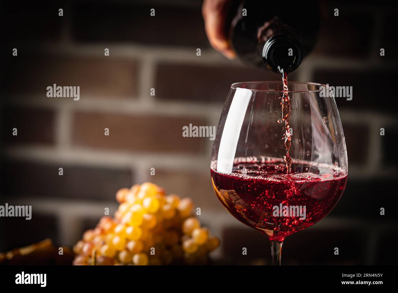 Pouring red wine Stock Photo - Alamy