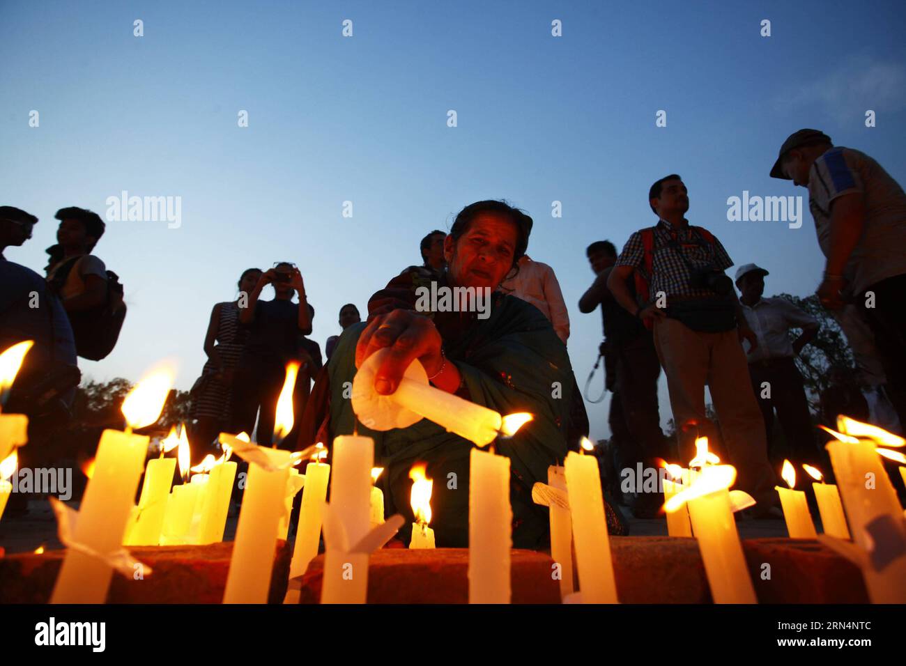 KATHMANDU, May 25, 2015 -- A woman lights candles in memory of victims ...