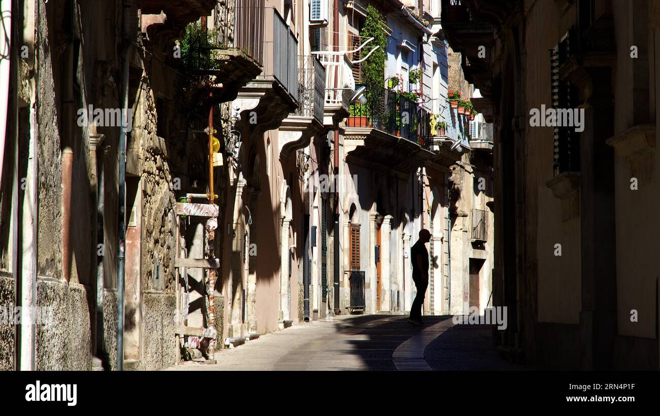 Old town alley, light and shadow, man as shadow, Ragusa Ibla, baroque ...
