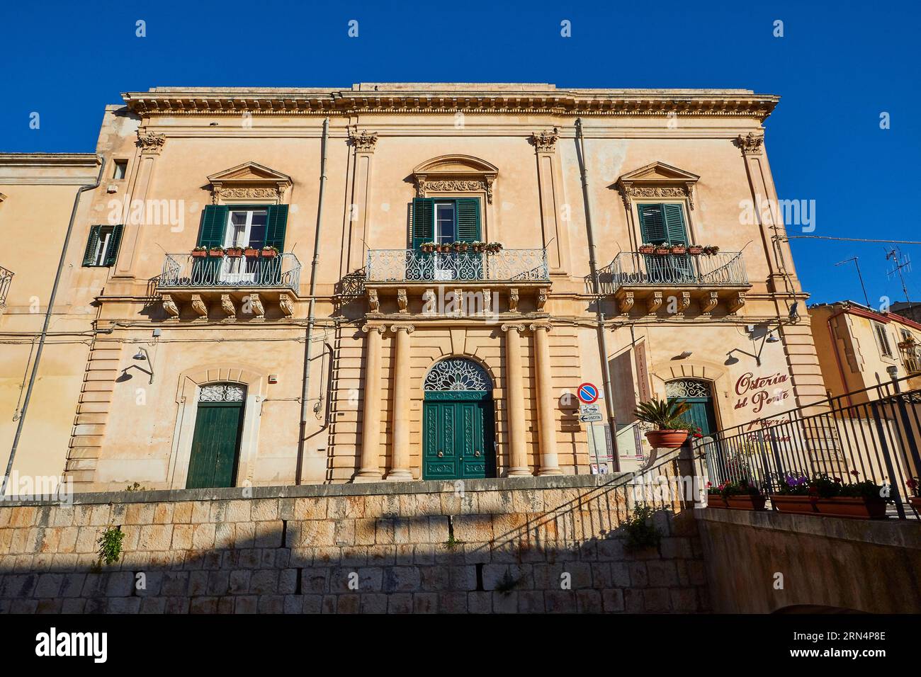 Two-storey historic building, Balconies, Green doors and shutters ...