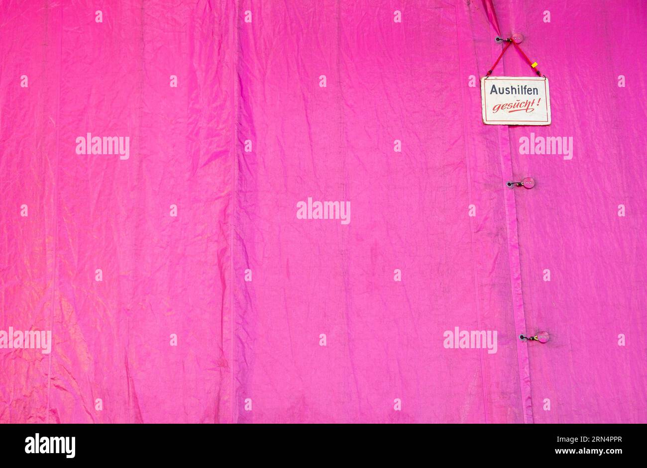 Sign on the tarpaulin at a funfair, temporary workers wanted ...