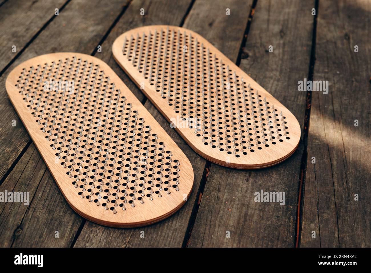 Sadhu board on wood background. The practice of standing on nails. Yoga ...