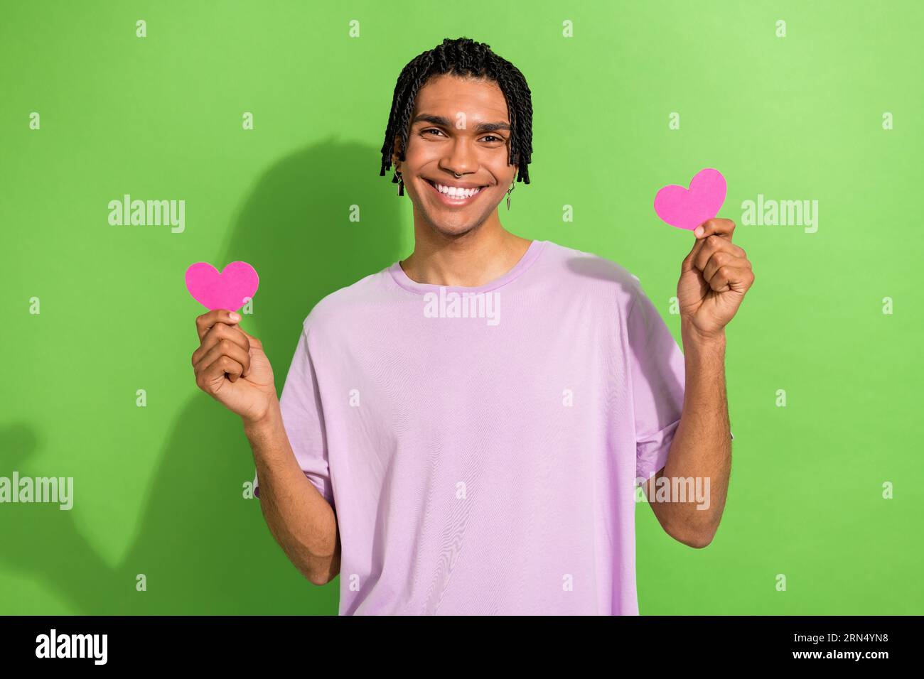 Photo of friendly attractive man toothy smile hands hold small heart ...