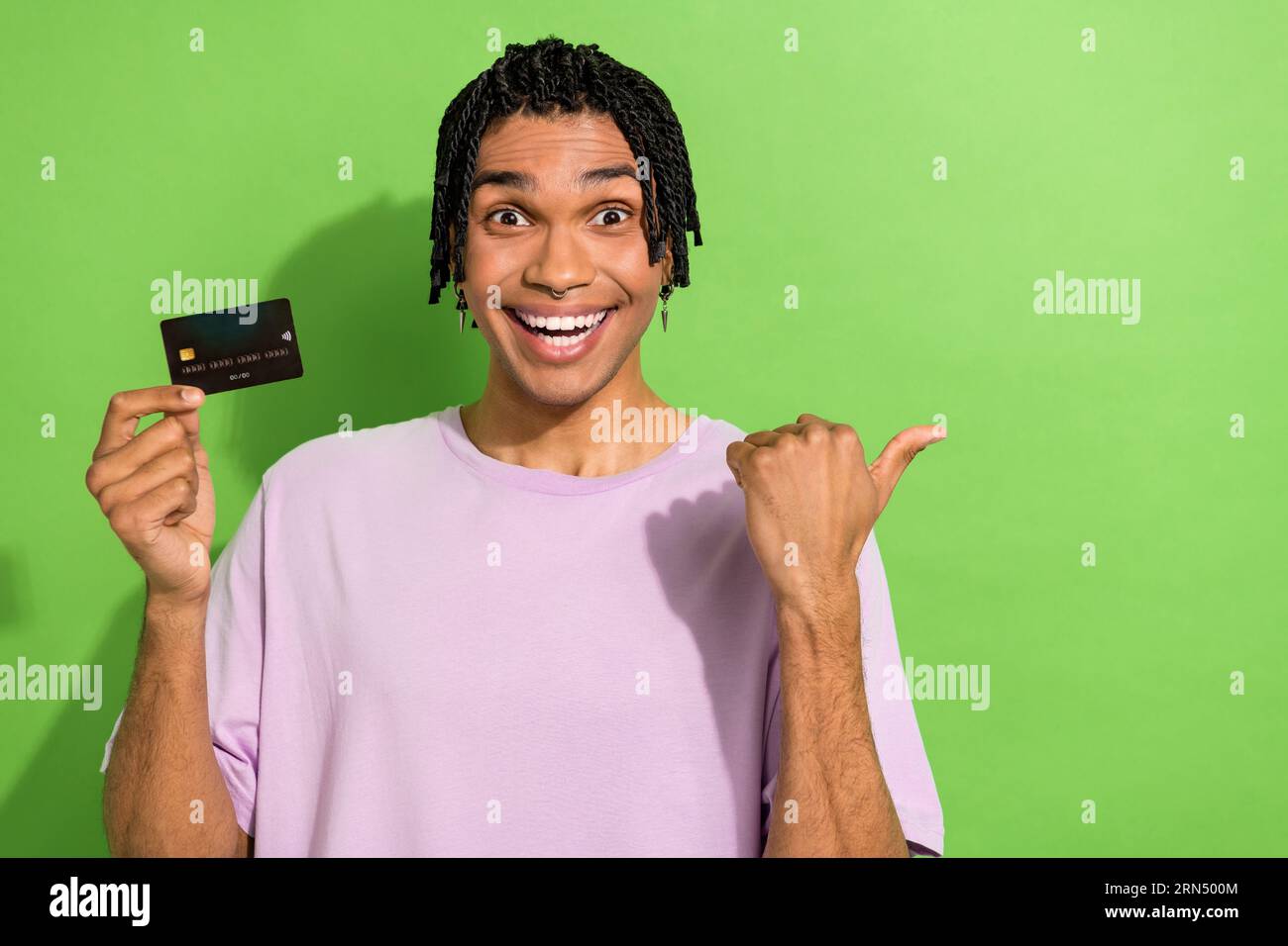 Portrait of impressed handsome guy hand hold debit card direct finger ...