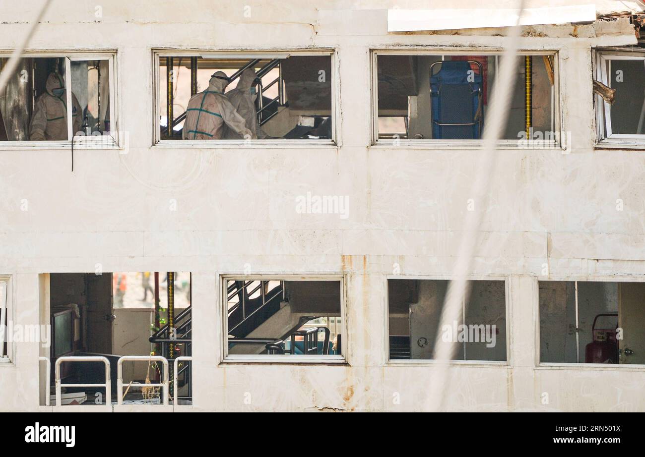 Rescuers work in the hull of the upright ship Eastern Star to launch ...