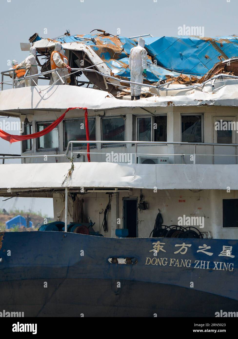 Rescuers work in the hull of the upright ship Eastern Star to launch ...