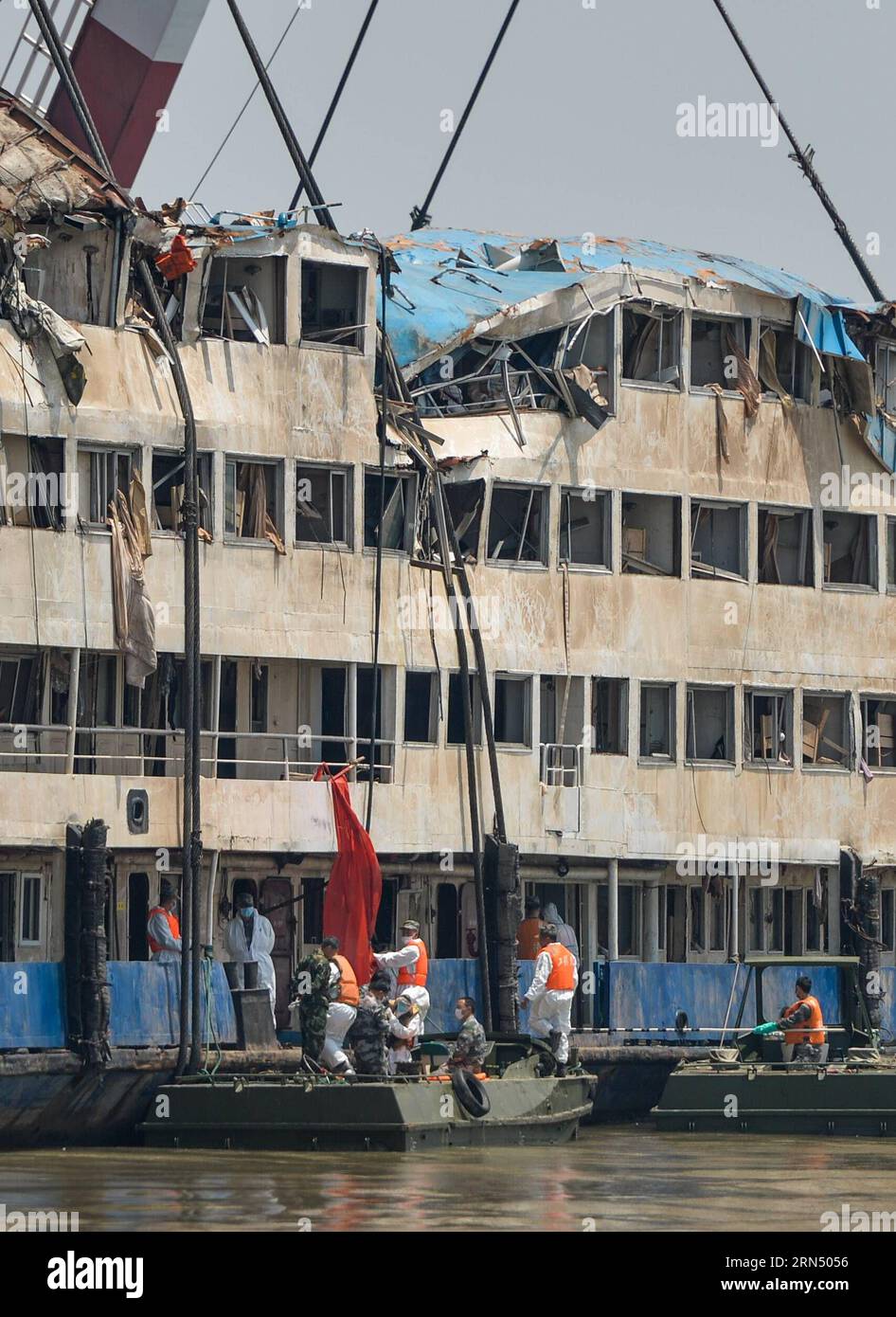 Rescuers work in the hull of the upright ship Eastern Star to launch ...