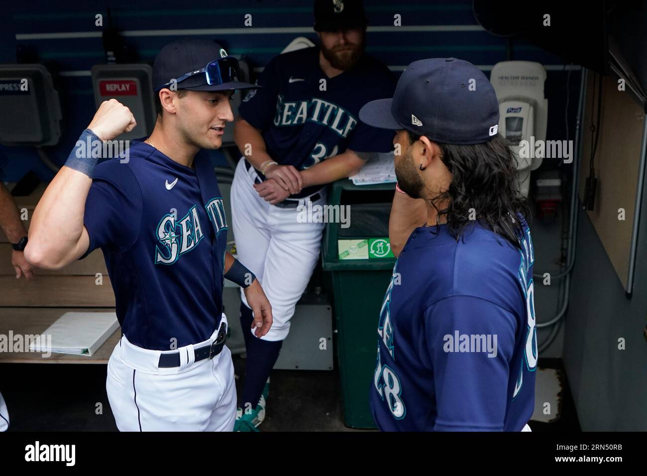 Seattle Mariners left fielder Dominic Canzone, left, greets third ...