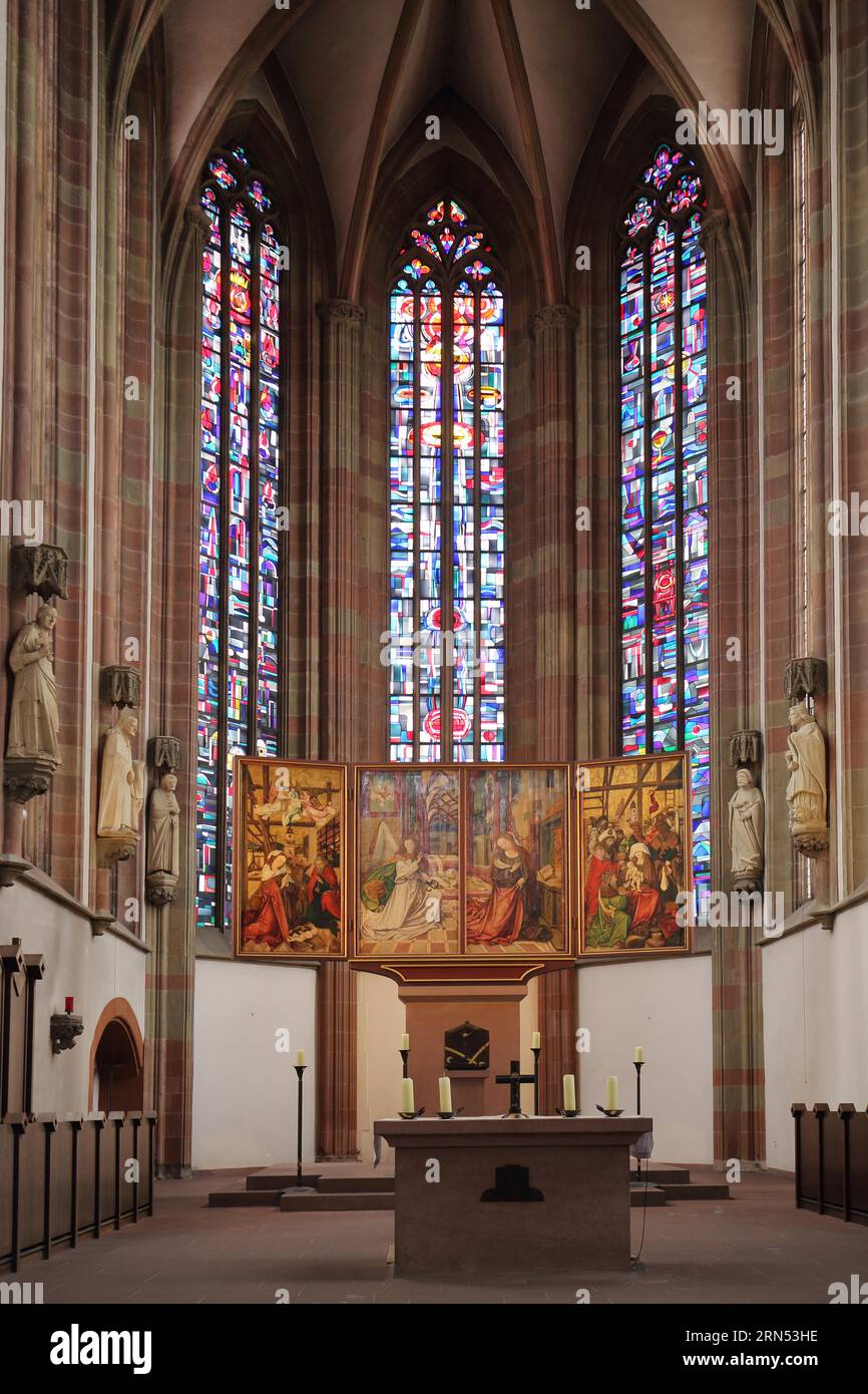 Interior view of the chancel with stained glass windows and folding ...
