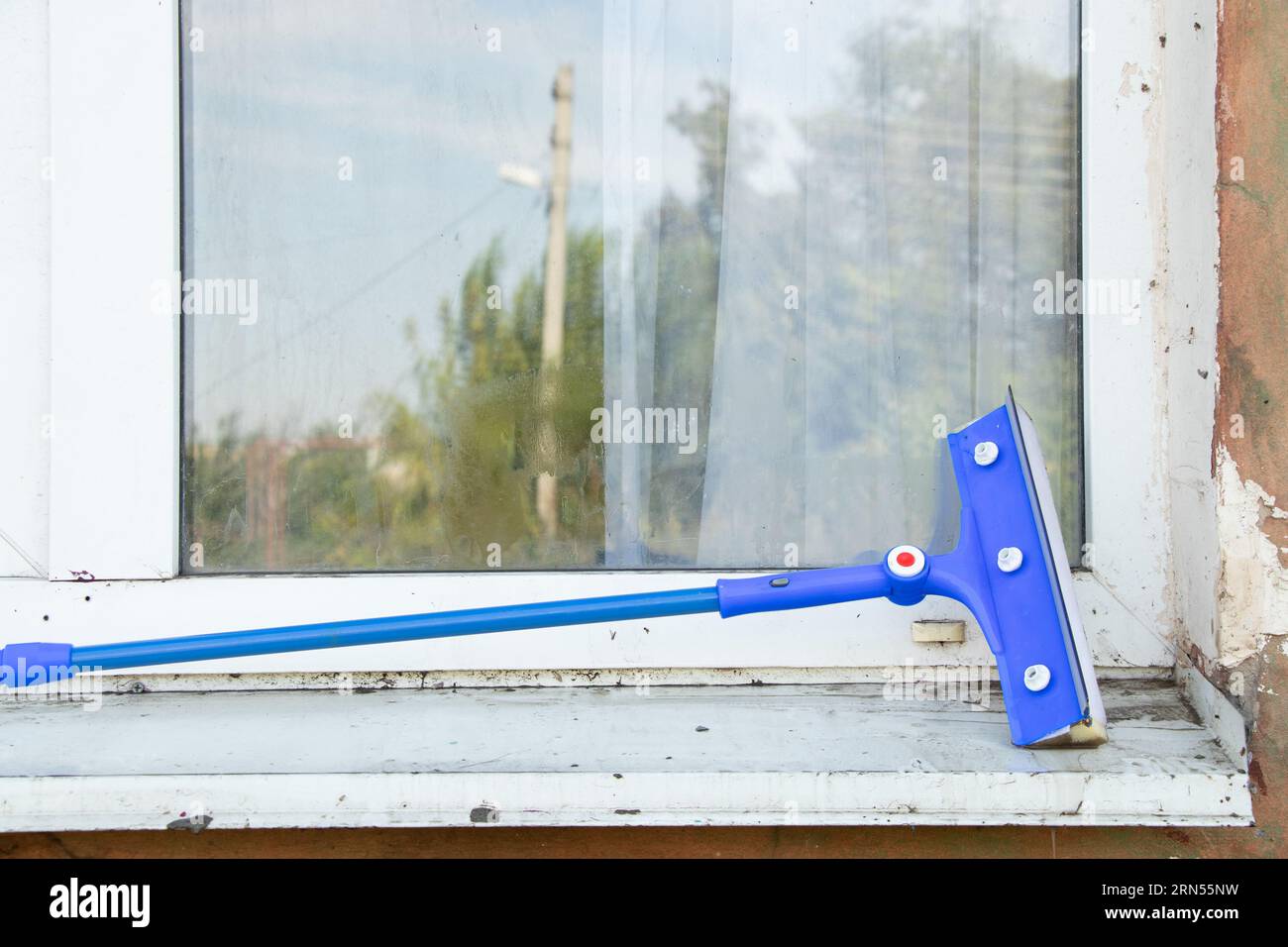 Wash a dirty window with a mop from the street, wash the windows, a mop ...