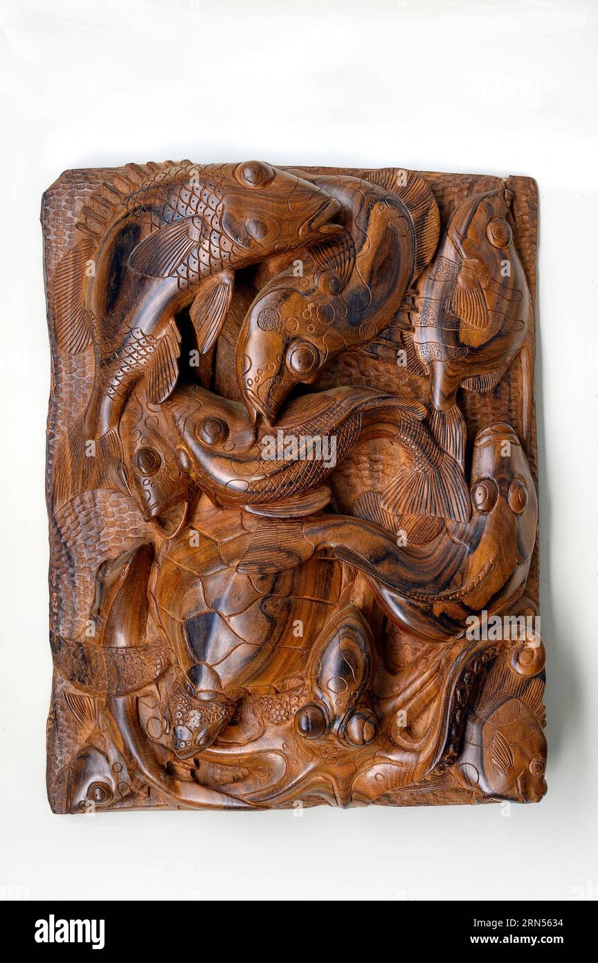 Souvenir, carving with fish, relief of John Wayne from Uepi Island ...