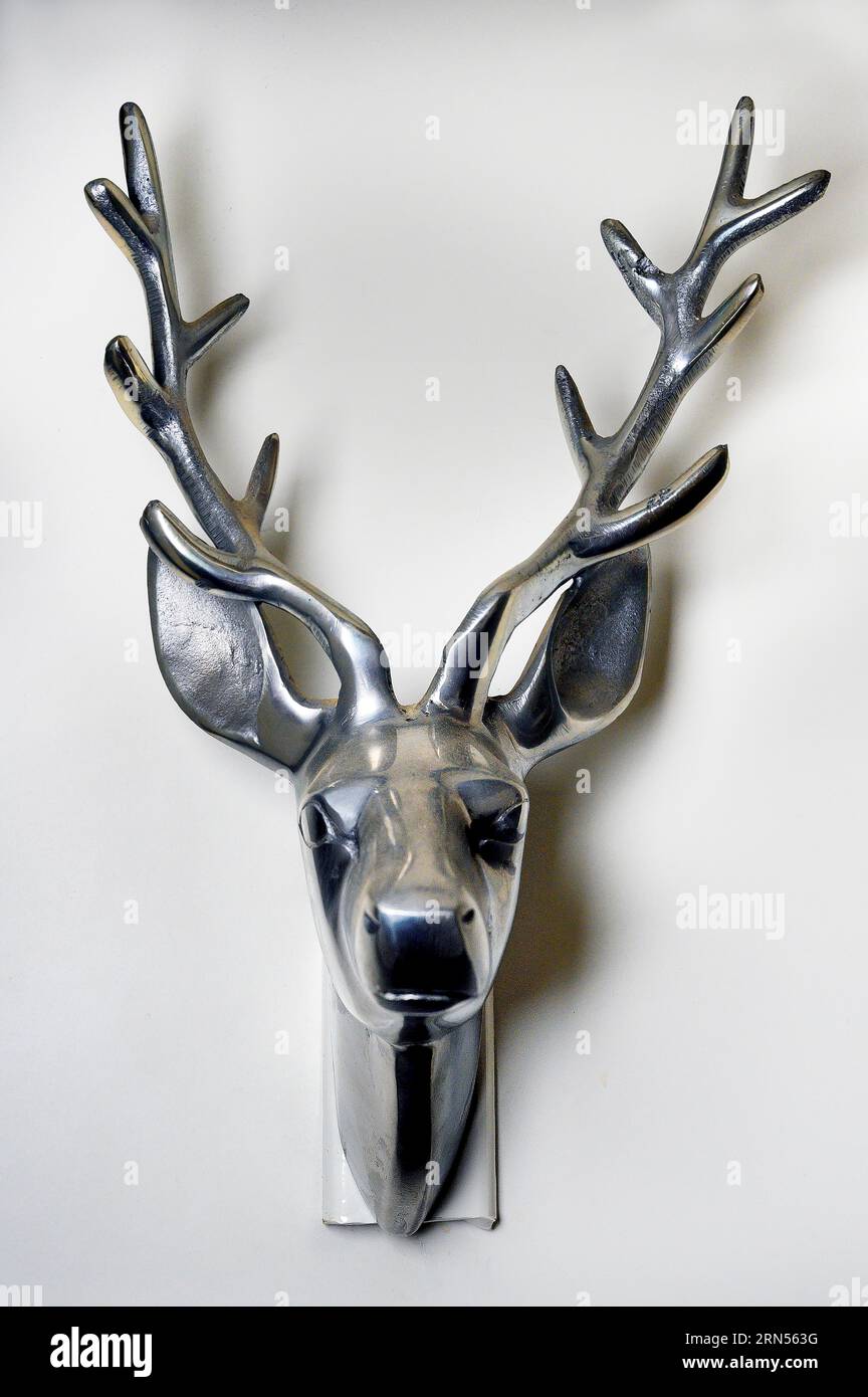Wall decoration, stylised deer head, silver, metal Stock Photo - Alamy