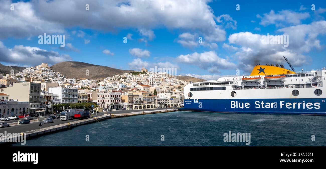 Town view with hills and houses of Ermoupoli town, ferry in Ermoupoli ...