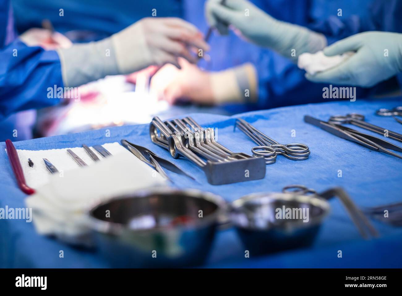 Operating table with surgical cutlery during an operation in a hospital ...