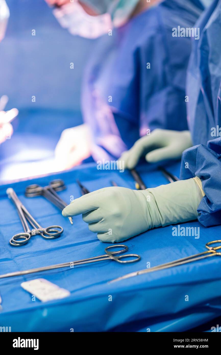 Operating table with surgical cutlery during an operation in a hospital ...