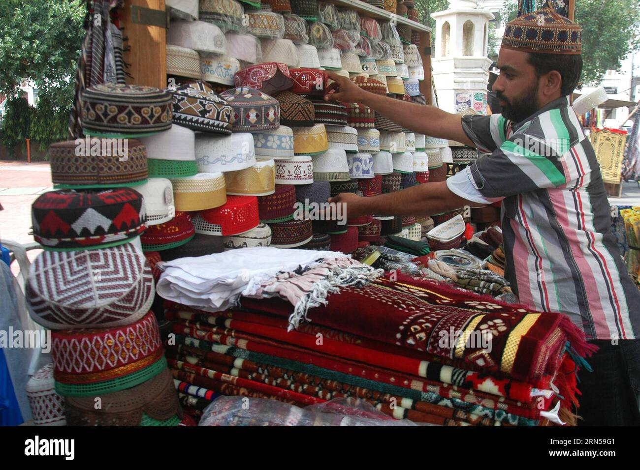 (150618) -- LAHORE, June 18, 2015 -- A man displays traditional caps at ...