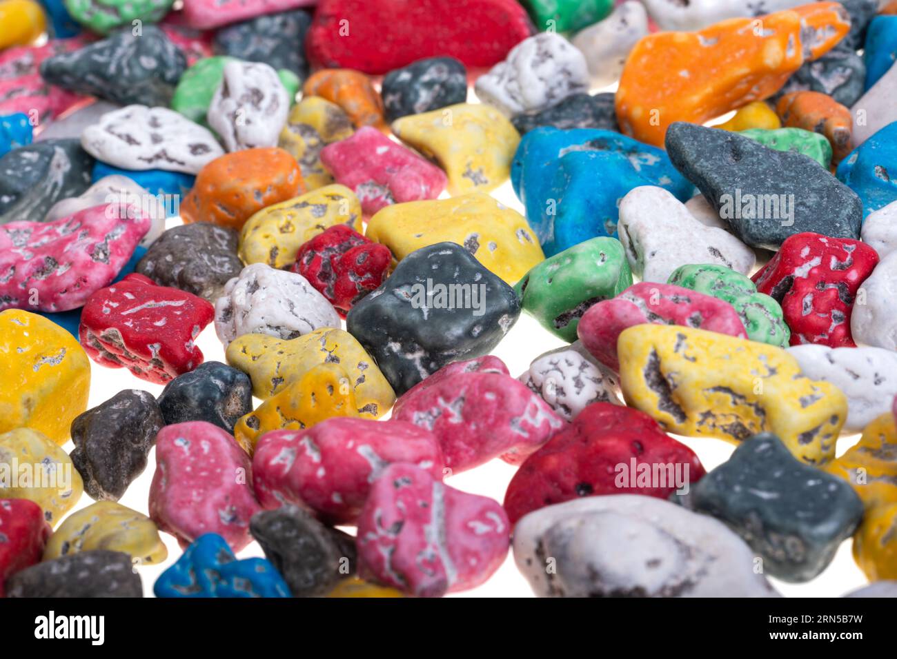 chocolate colored pebbles on a white background Stock Photo - Alamy