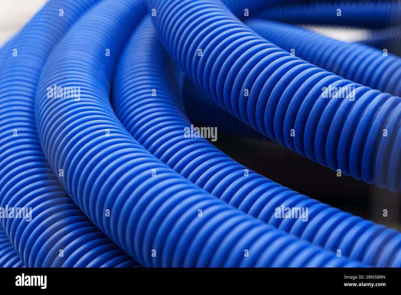 There is a blue corrugated pipe on the construction site. The texture ...