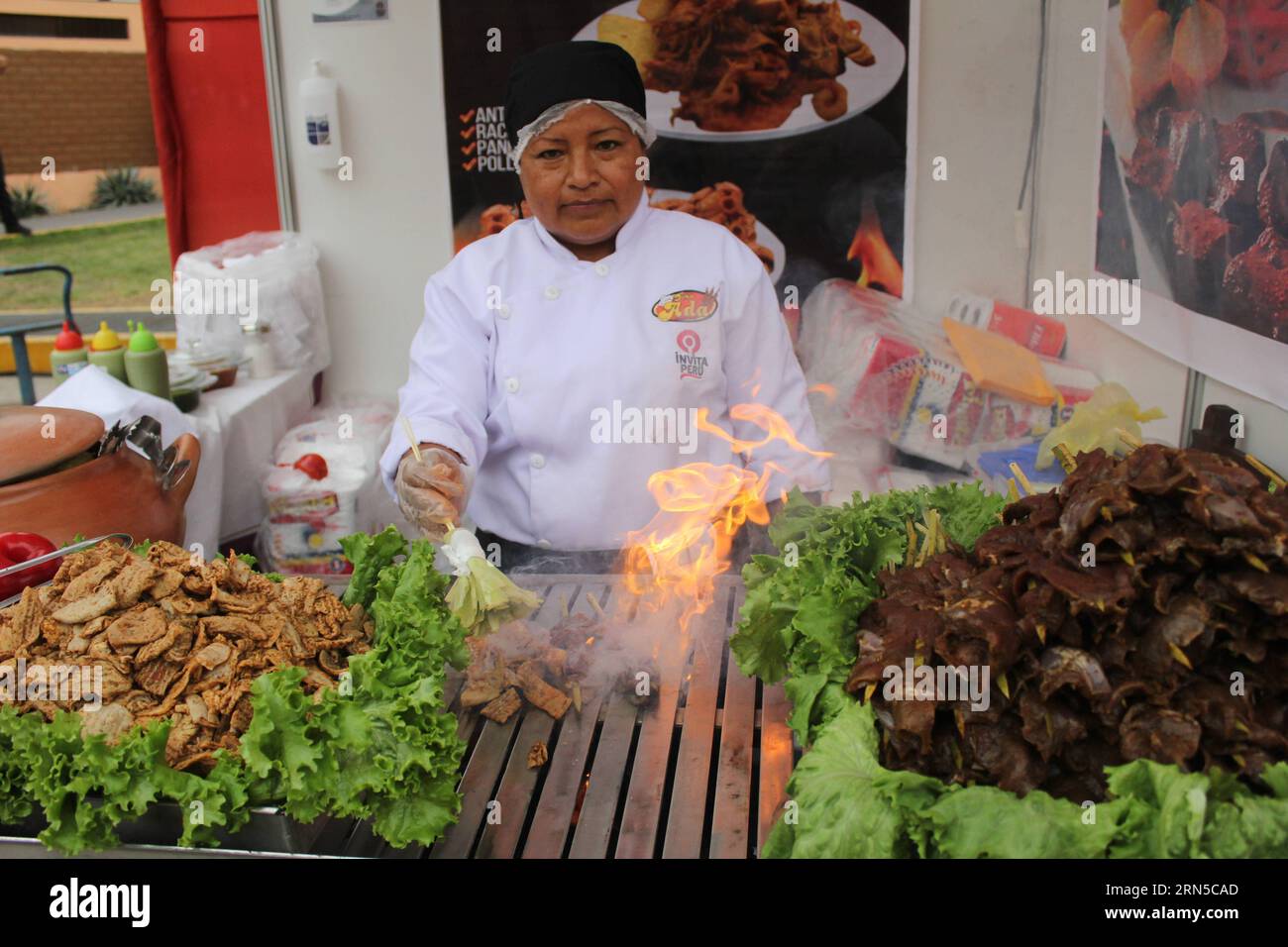 A cook prepares the dishes anticuchos and rachi , made with the heart ...