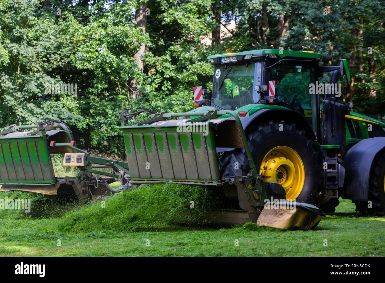 Grass mowing in a small field near Waldheim with a John Deere tractor ...
