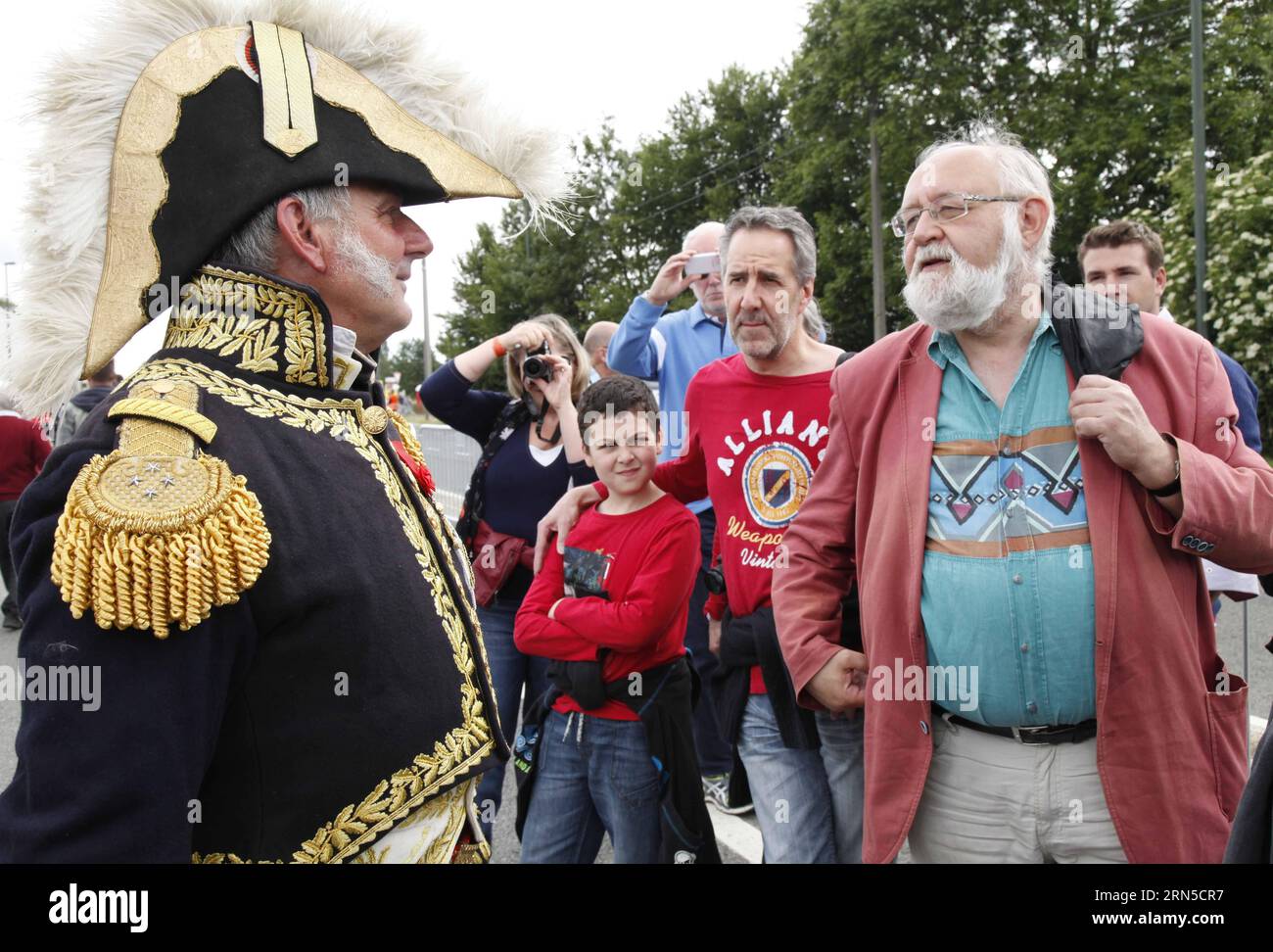 (150621)-- WATERLOO, Tourists talk with a man enacting a general of ...