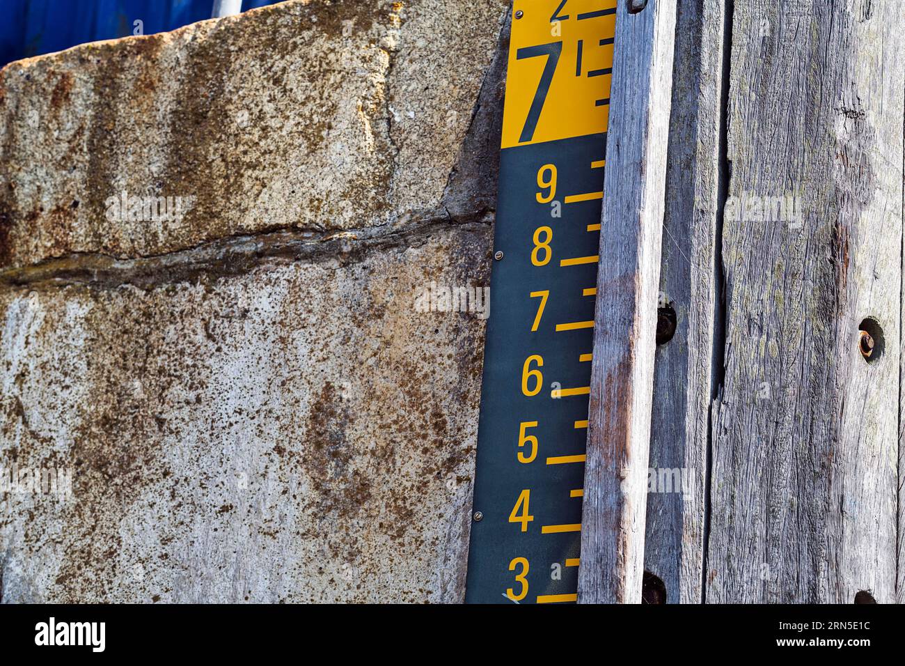 Water level gauge in the harbour basin at high tide and flood, water ...