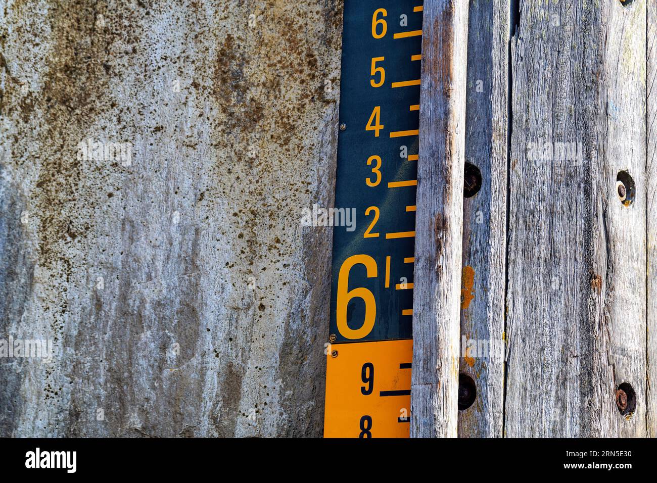 Water level gauge in the harbour basin at high tide and flood, water ...