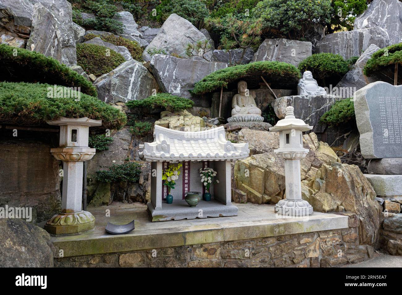 Small shrine and stone Buddha figures, on the grounds of Haedong ...