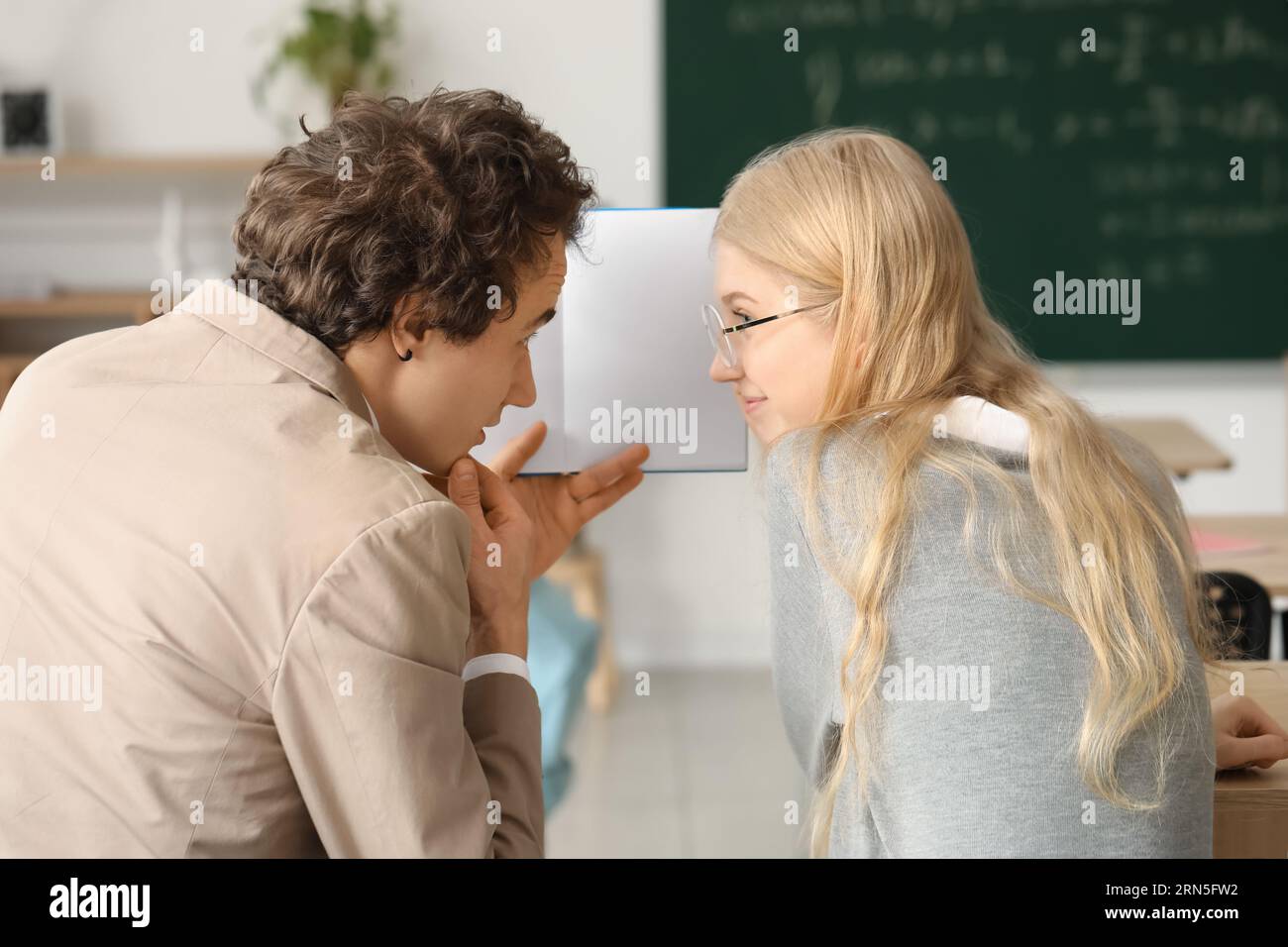 Teen boy girl sitting classroom talking hi-res stock photography and ...