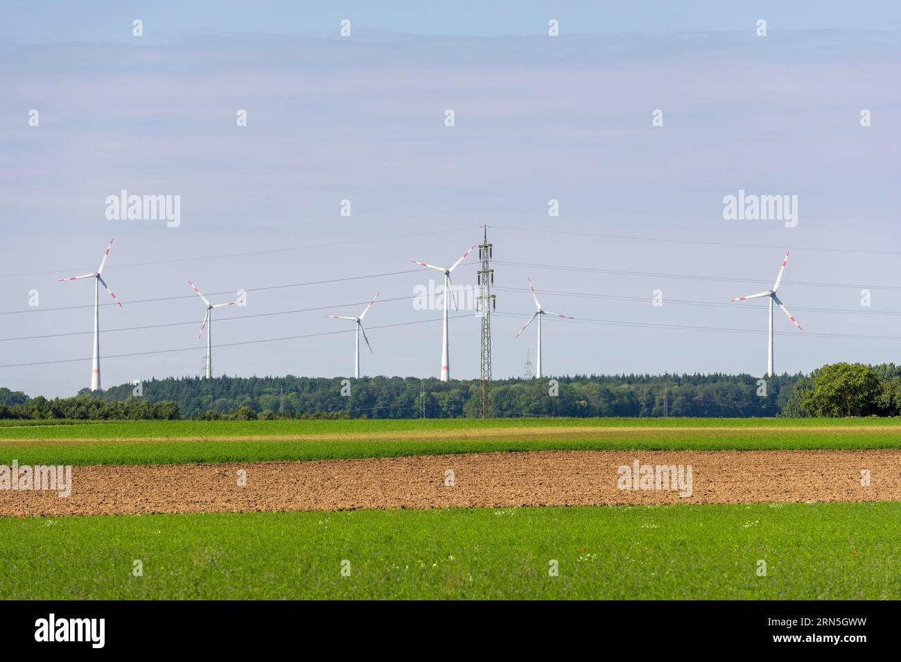 Field landscape with wind turbines and transmission lines ...